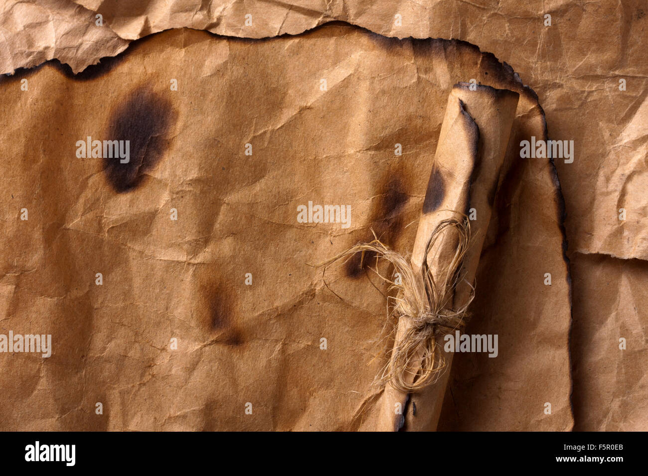 Background of old paper with rolled message Stock Photo - Alamy