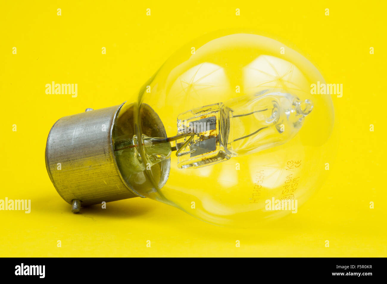 A light bulb on a yellow background Stock Photo - Alamy