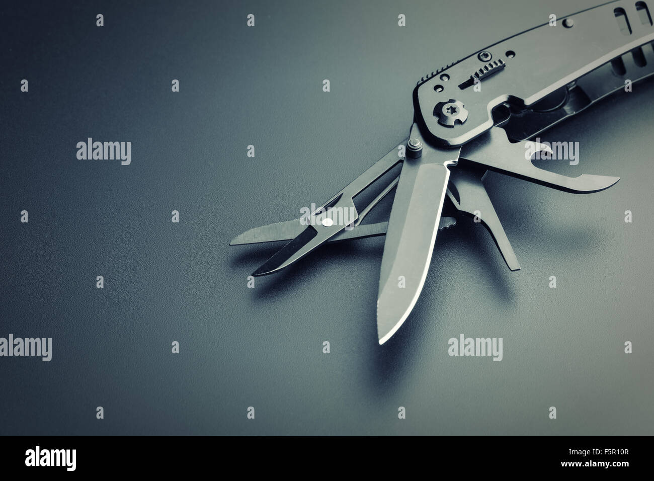 Black opened multitool knife closeup view Stock Photo - Alamy