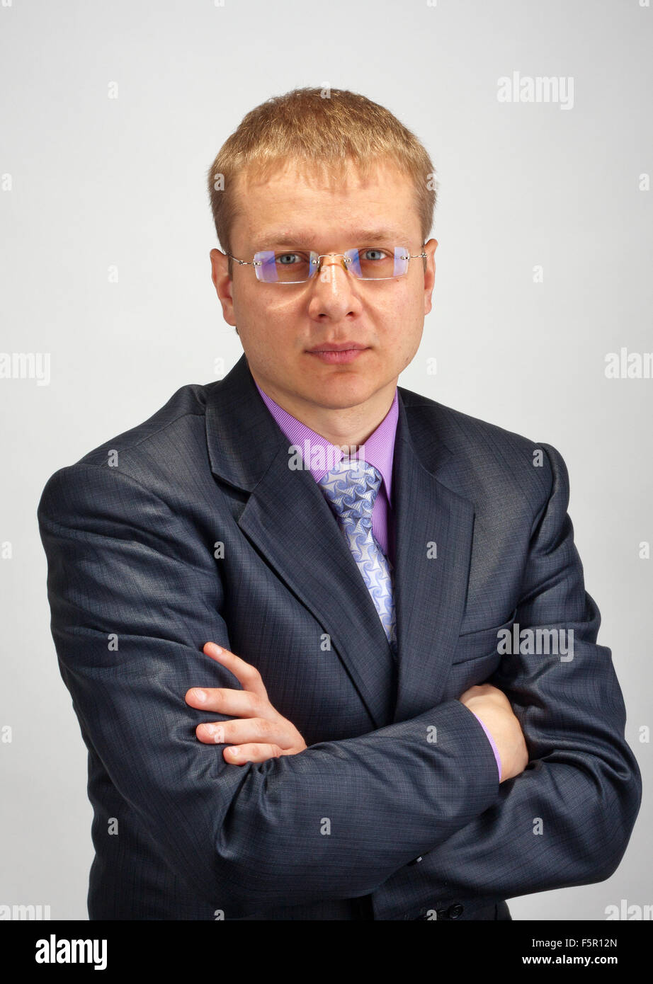Portrait of successful businessman with crossed arms Stock Photo - Alamy