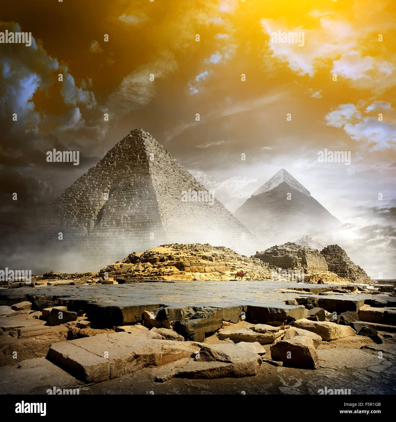 Orange storm clouds and fog over egyptian pyramids Stock Photo - Alamy
