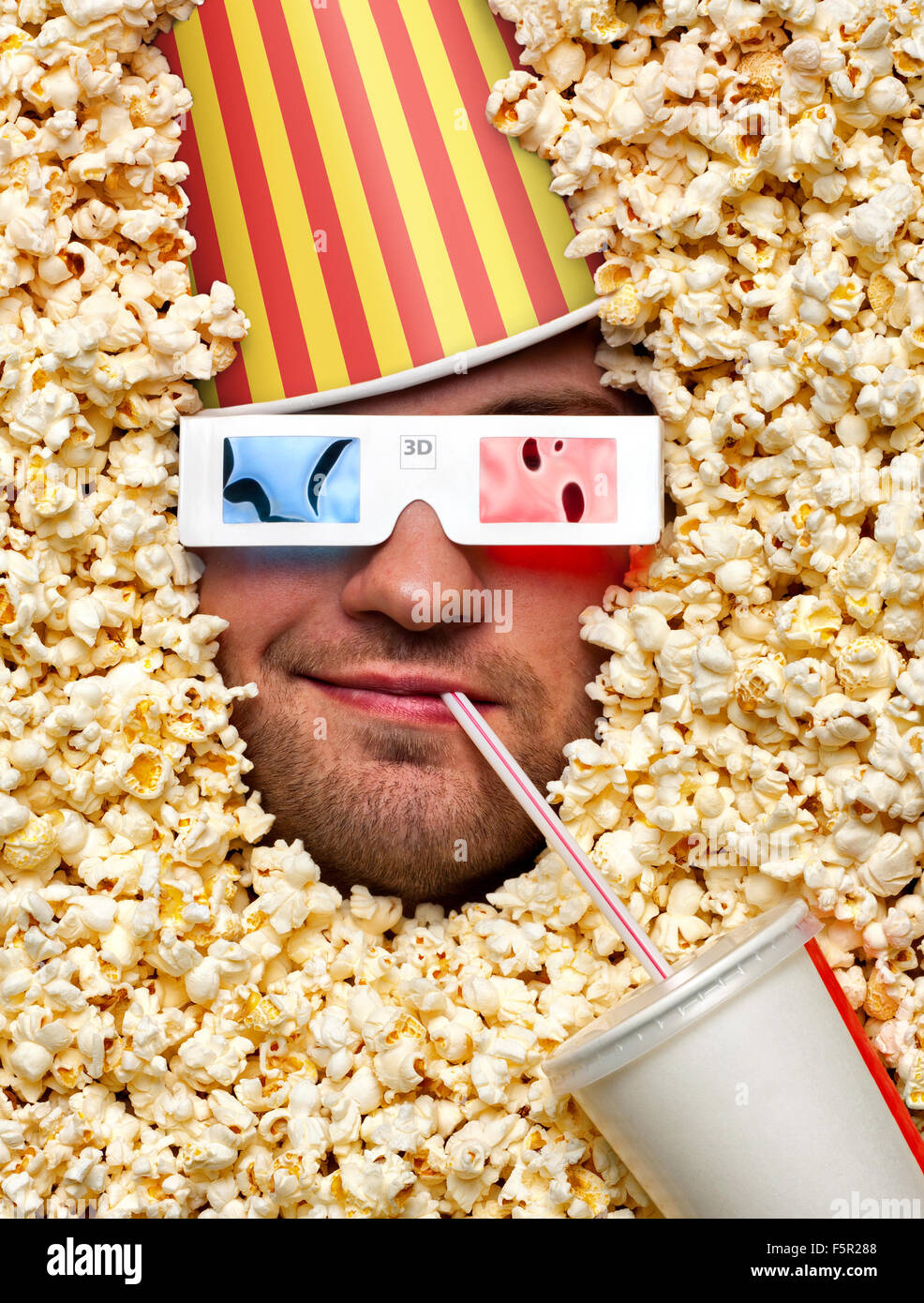 Happy face in popcorn with bucket on head watching 3D movie and ...