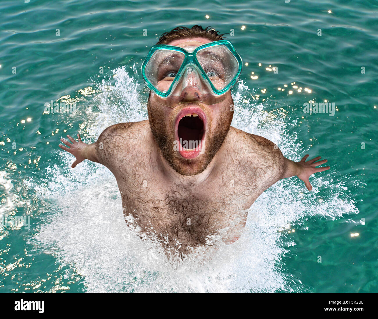 Man with swimming mask leaping out from water to breath air Stock Photo ...