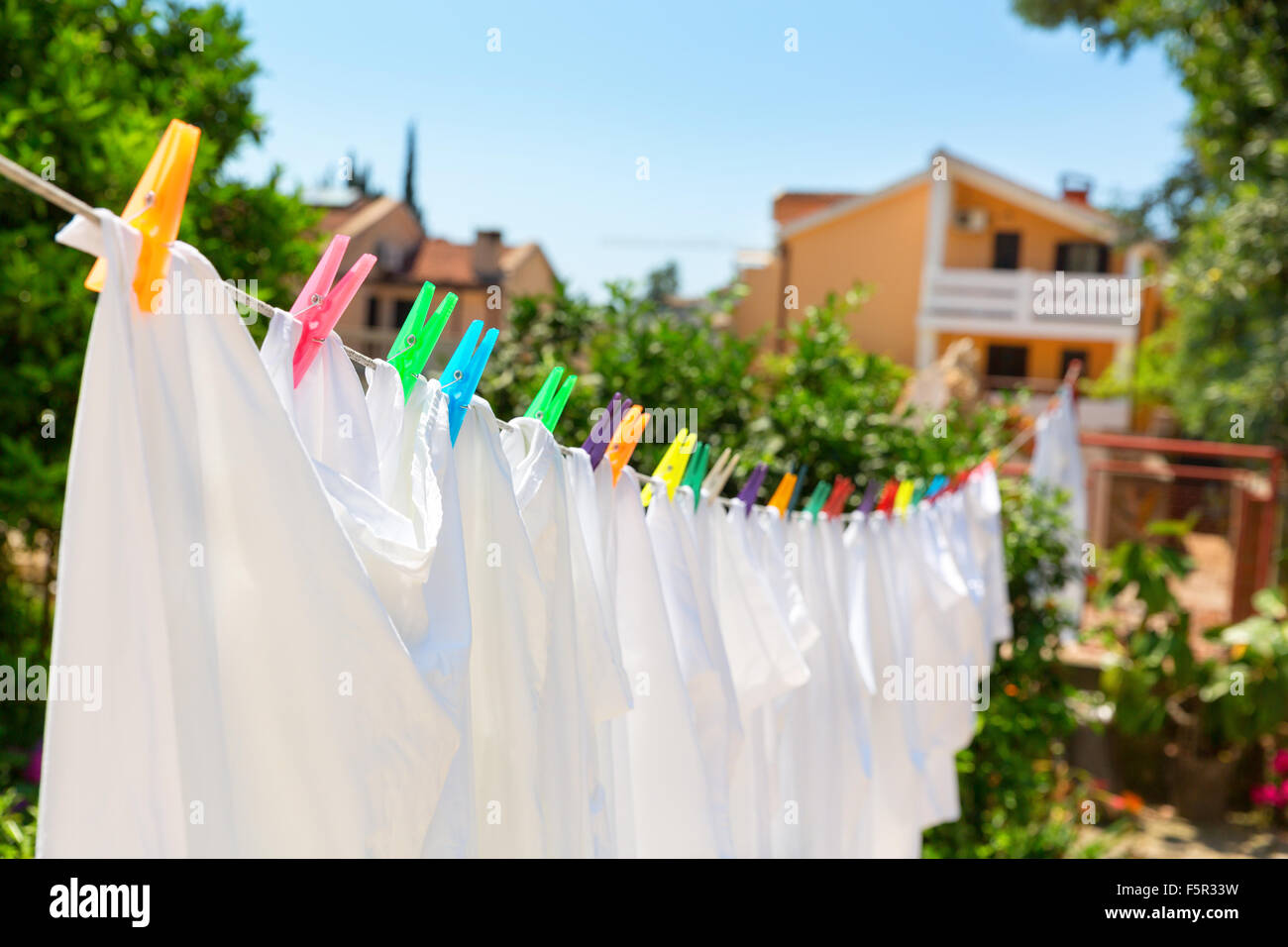 Cloth with colorful pins is drying at the yard Stock Photo - Alamy
