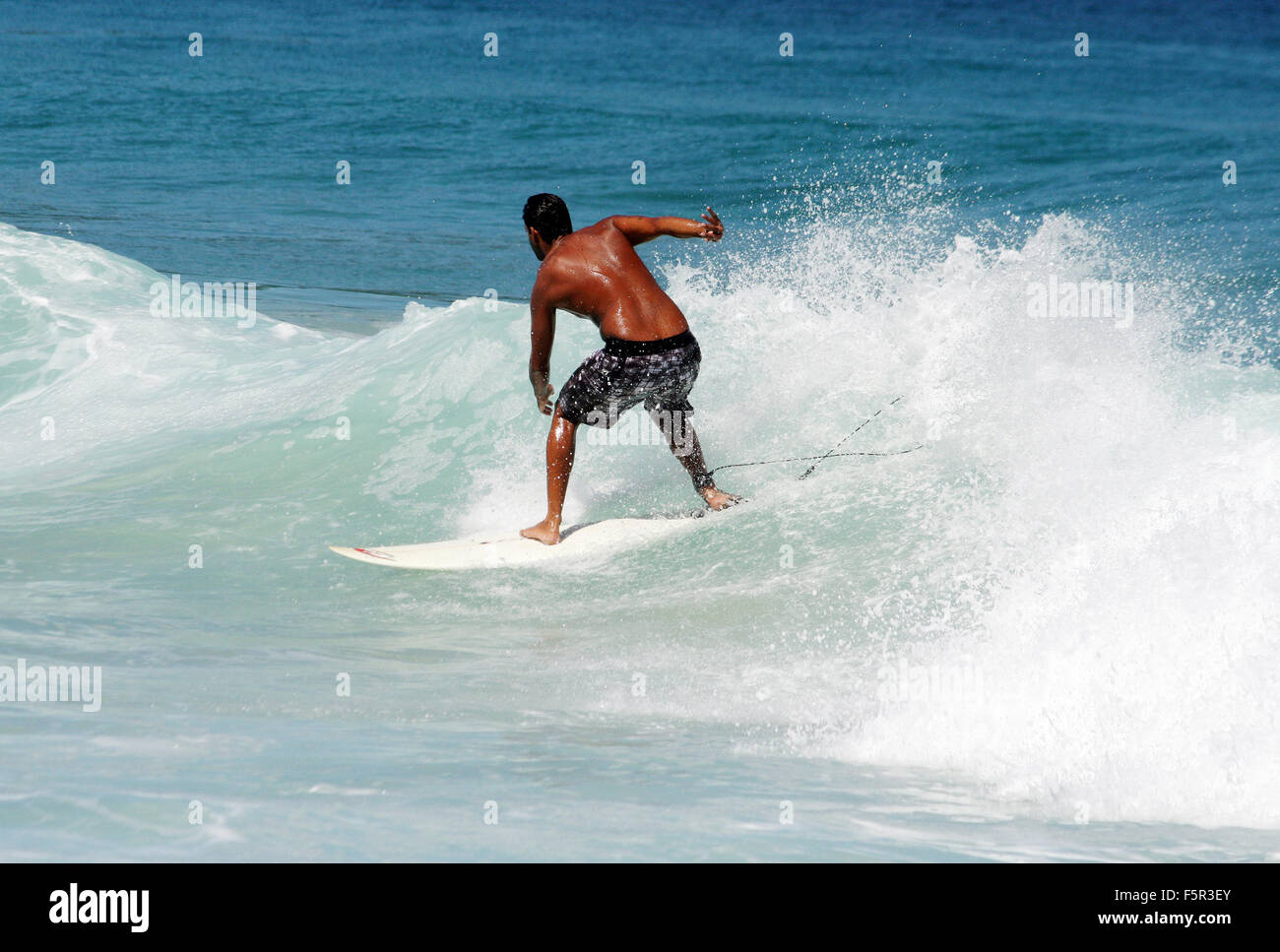 Young boy surfing perfect waves in hte sea Stock Photo - Alamy