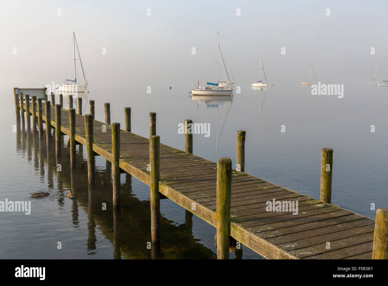 A wooden jetty on Lake Windermere close to a yacht mooring Stock Photo ...