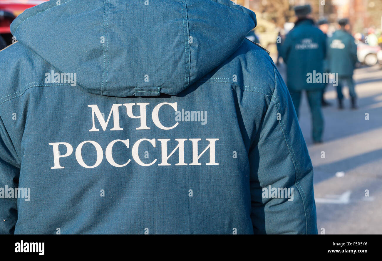 Russian emercom officer in uniform standing in the cordon. Text on ...