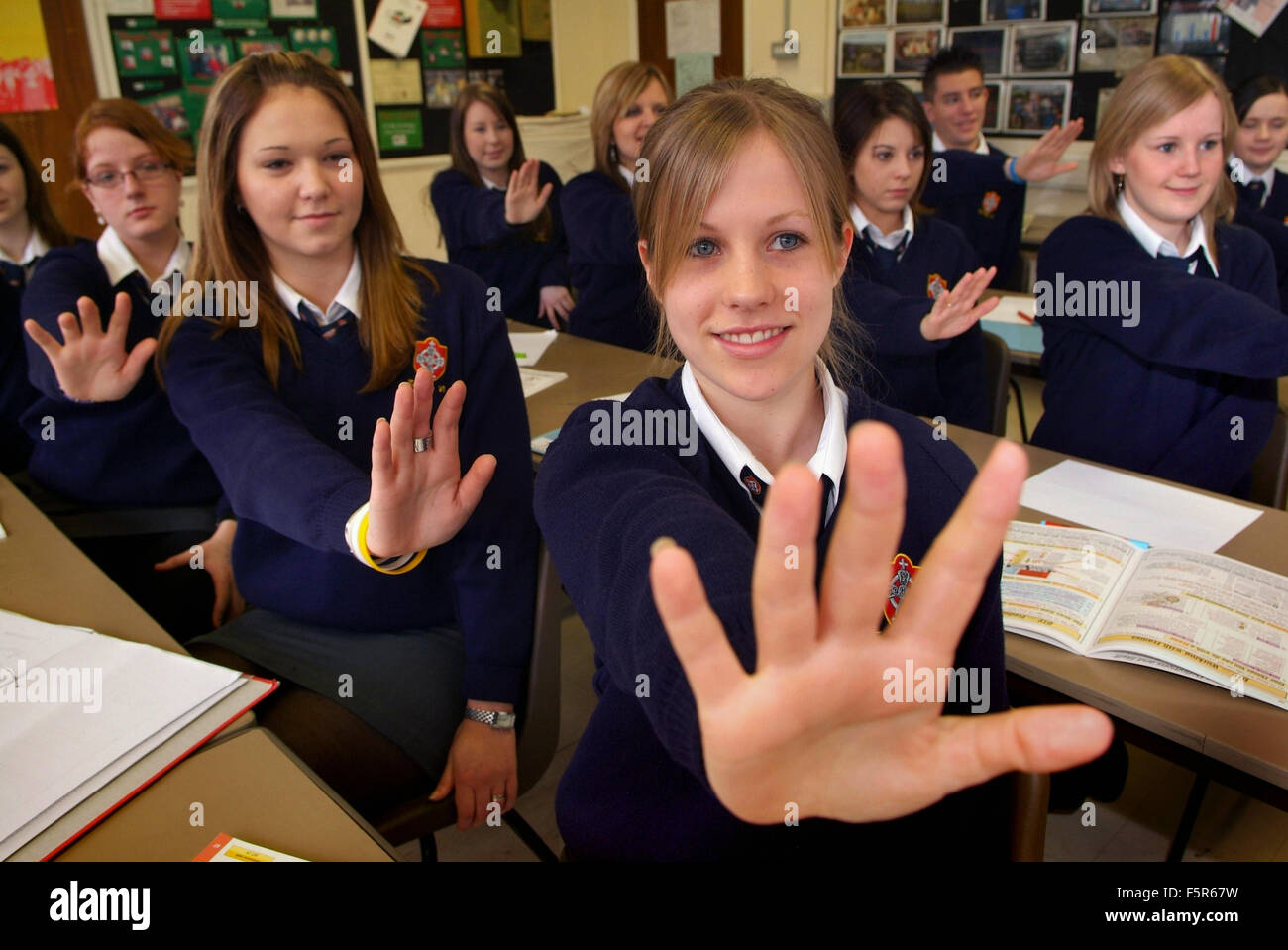 Sixth form female students doing exercises at their desks in the ...