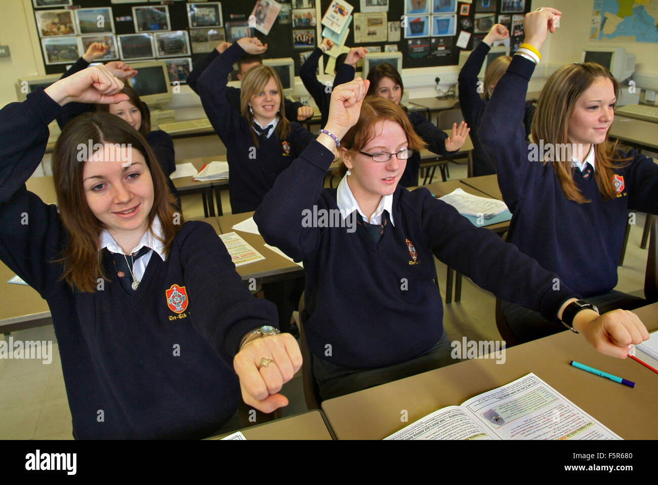 Sixth form female students doing exercises at their desks in the ...