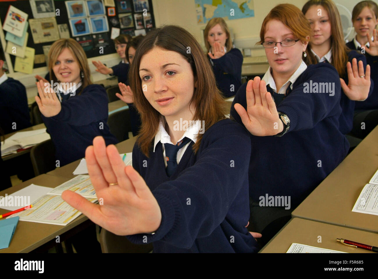 Sixth form female students doing exercises at their desks in the ...