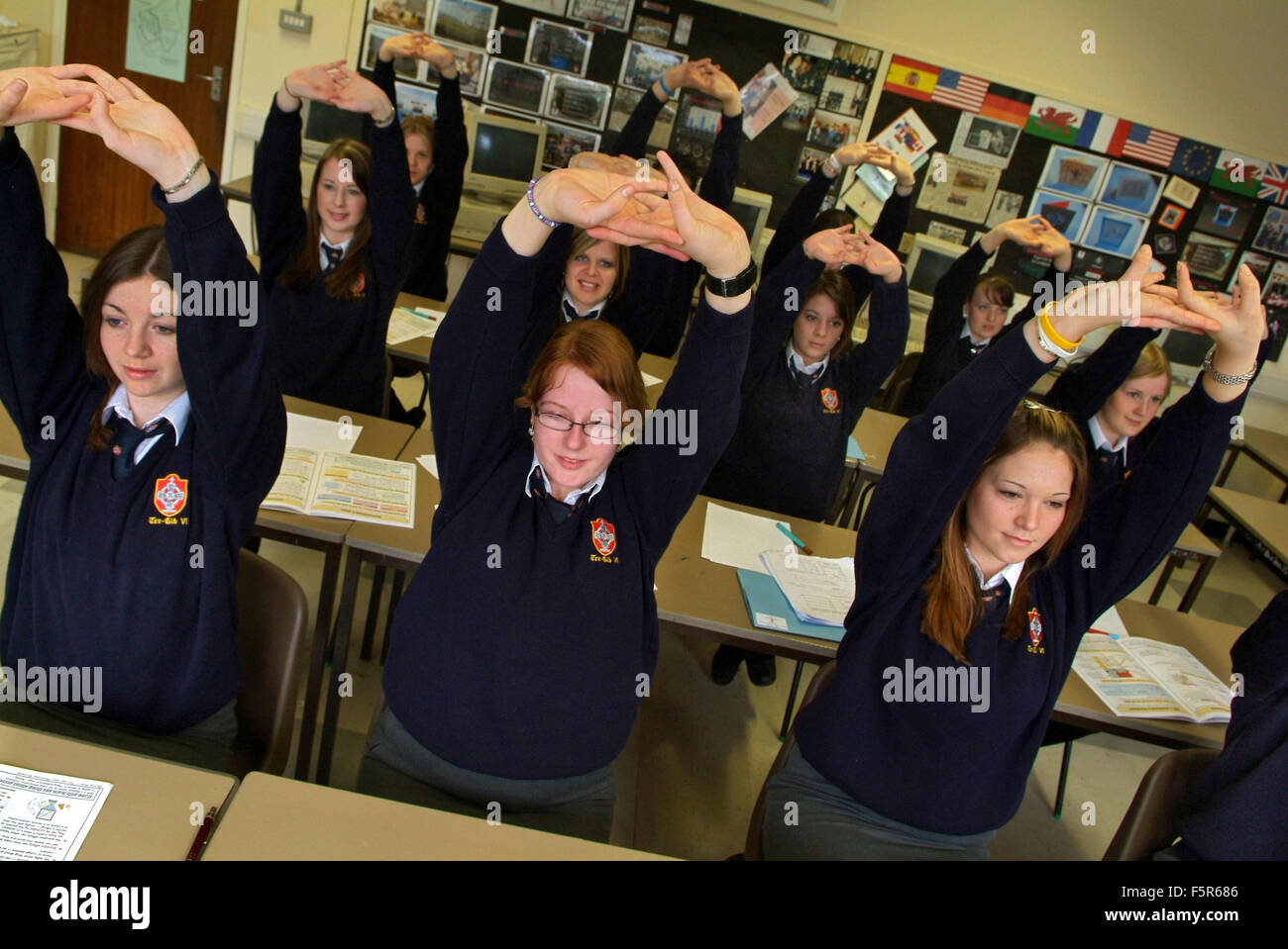 Sixth form female students doing exercises at their desks in the ...