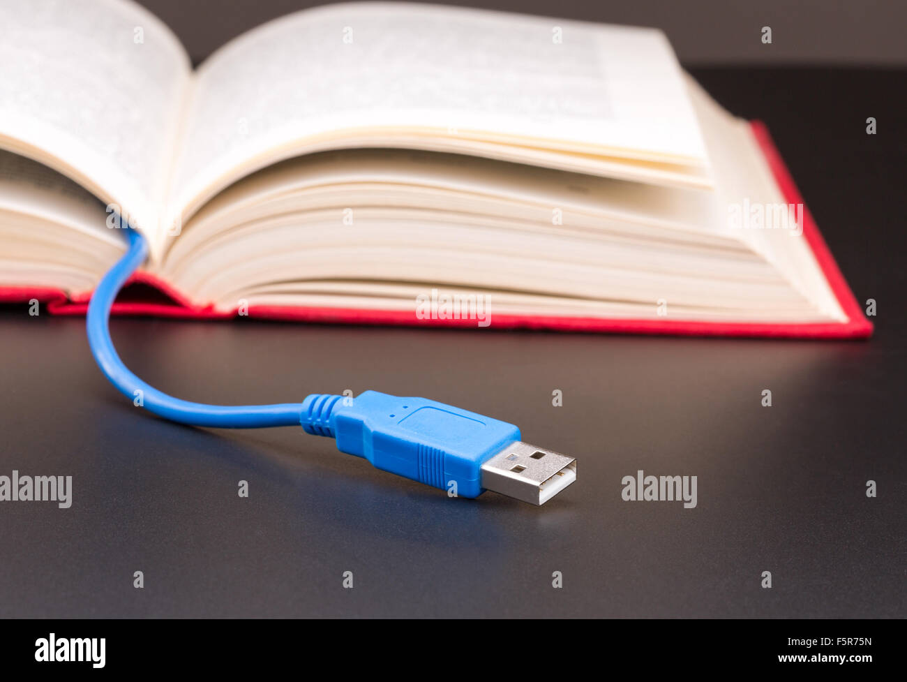 Blue usb cable sticks out from red book Stock Photo - Alamy