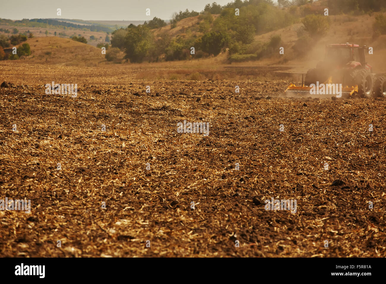 Agricultural Landscape. Tractor working on the field Stock Photo - Alamy