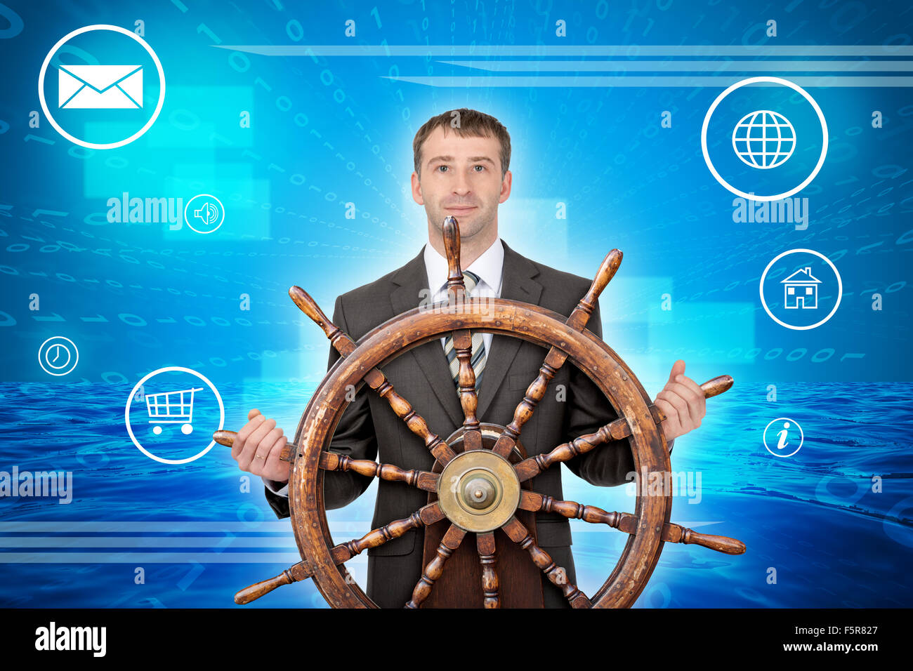 Smiling man with steering wheel and computer icons Stock Photo - Alamy