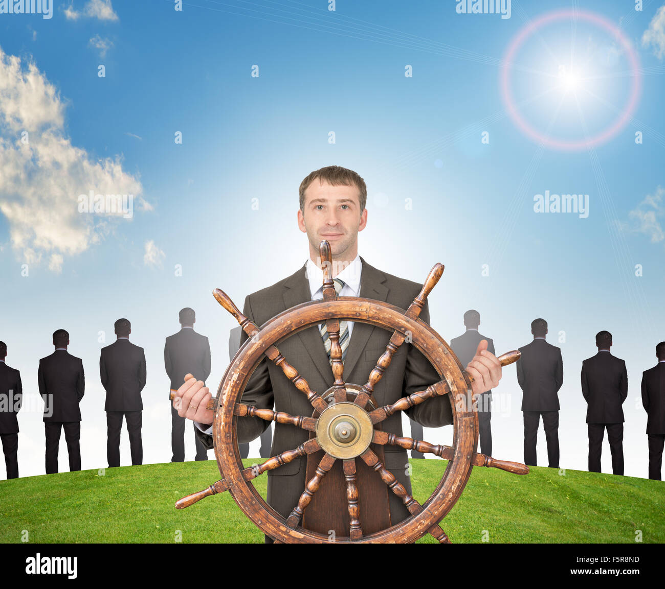 Smiling man with steering wheel and people Stock Photo - Alamy