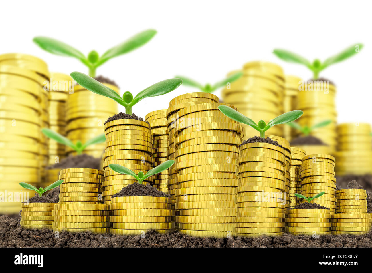 Stack of golden coins with ground and plant Stock Photo - Alamy