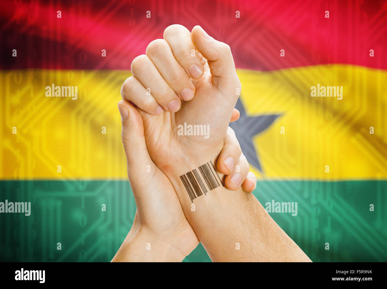Barcode ID number on wrist of a human and national flag on background ...