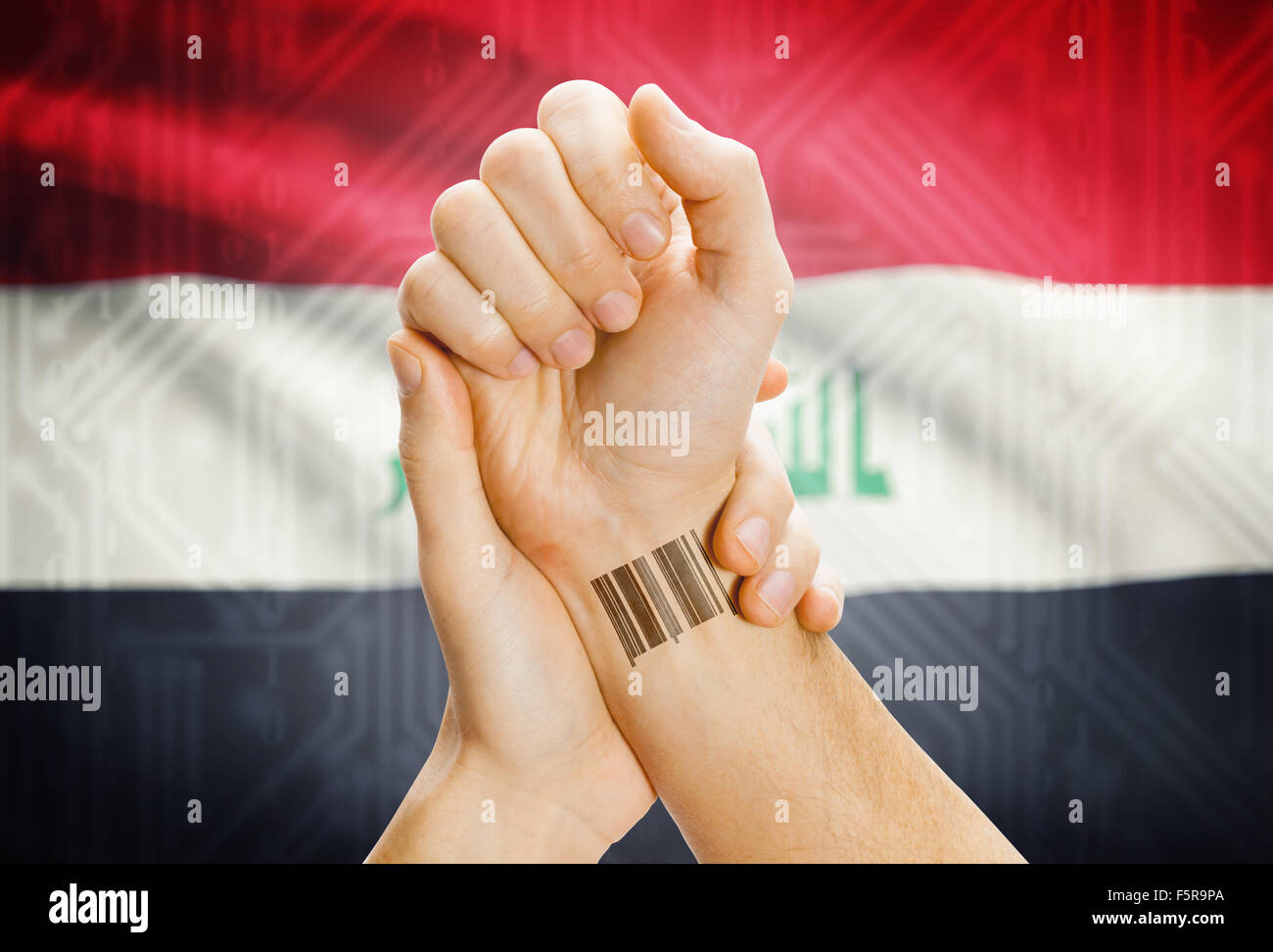 Barcode ID number on wrist of a human and national flag on background ...