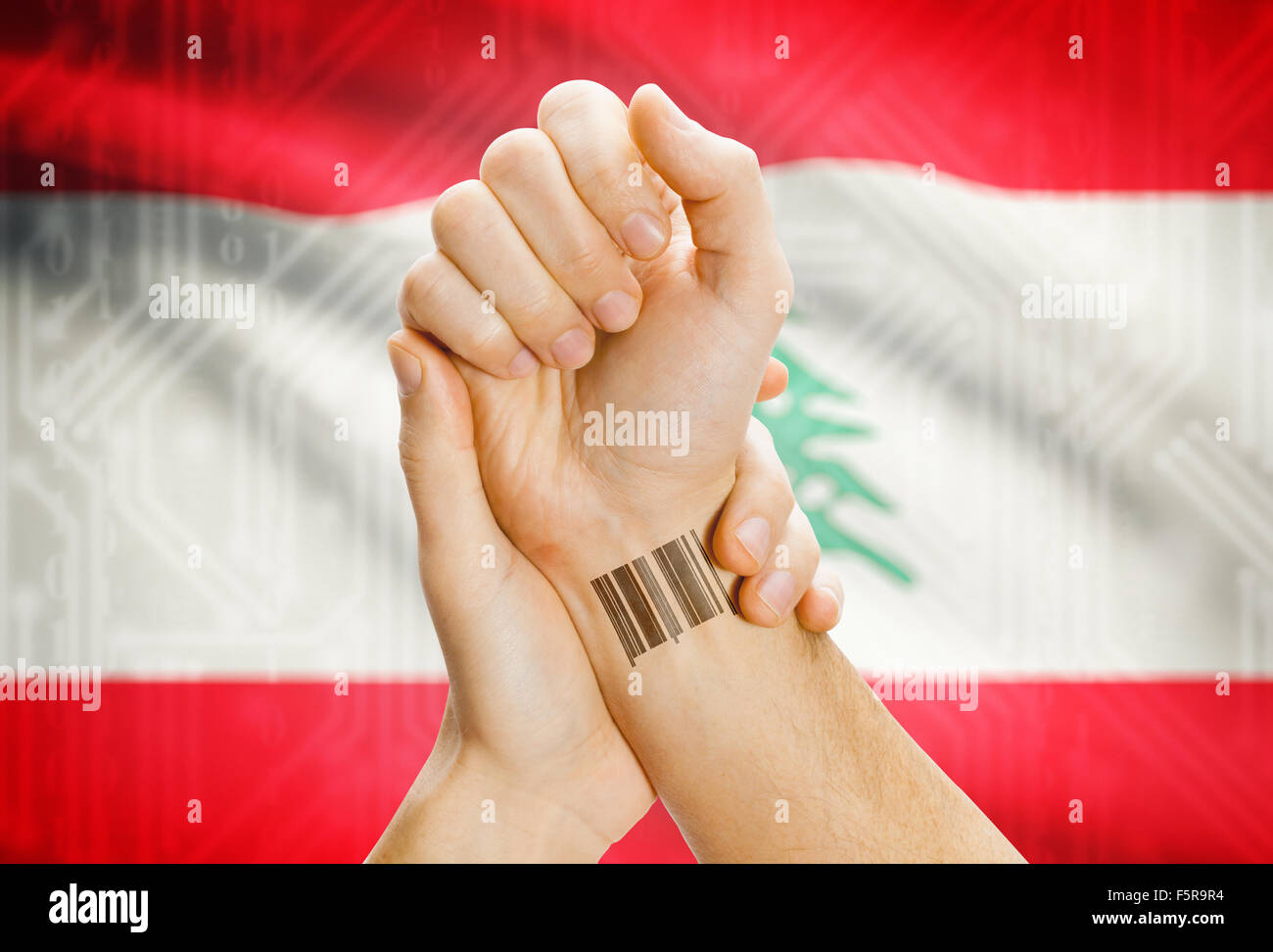 Barcode ID number on wrist of a human and national flag on background ...