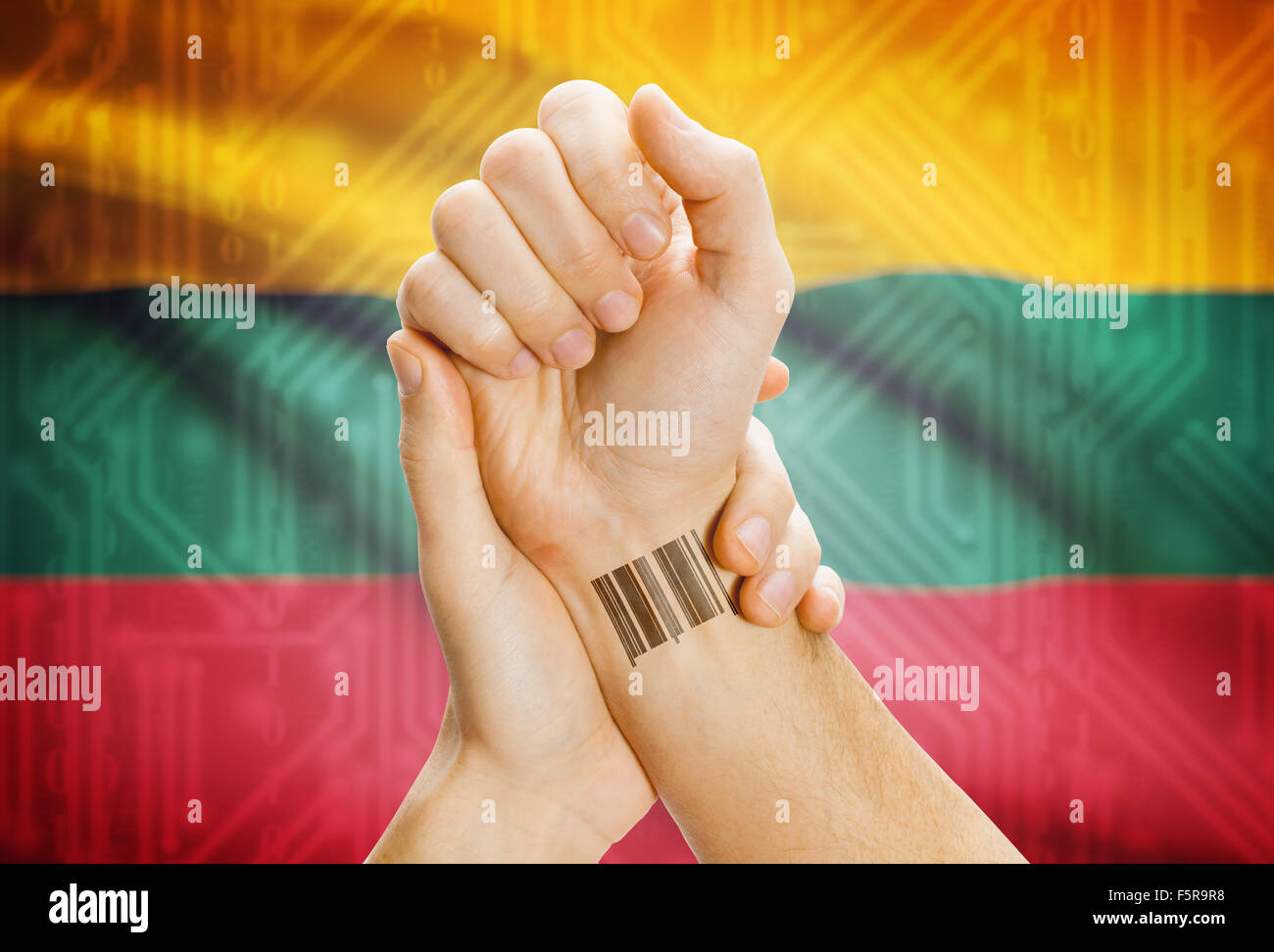 Barcode ID number on wrist of a human and national flag on background ...
