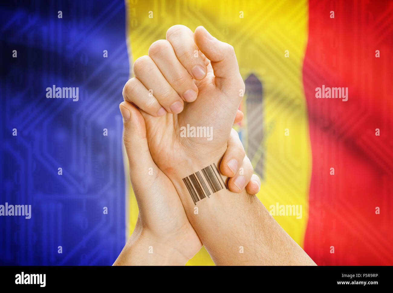 Barcode ID number on wrist of a human and national flag on background ...
