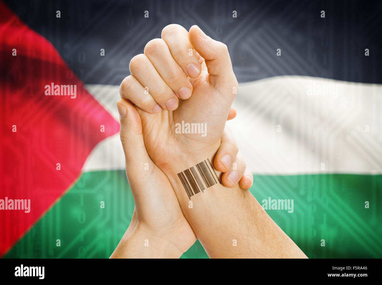 Barcode ID number on wrist of a human and national flag on background ...
