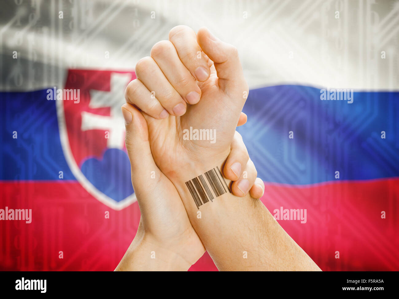 Barcode ID number on wrist of a human and national flag on background ...