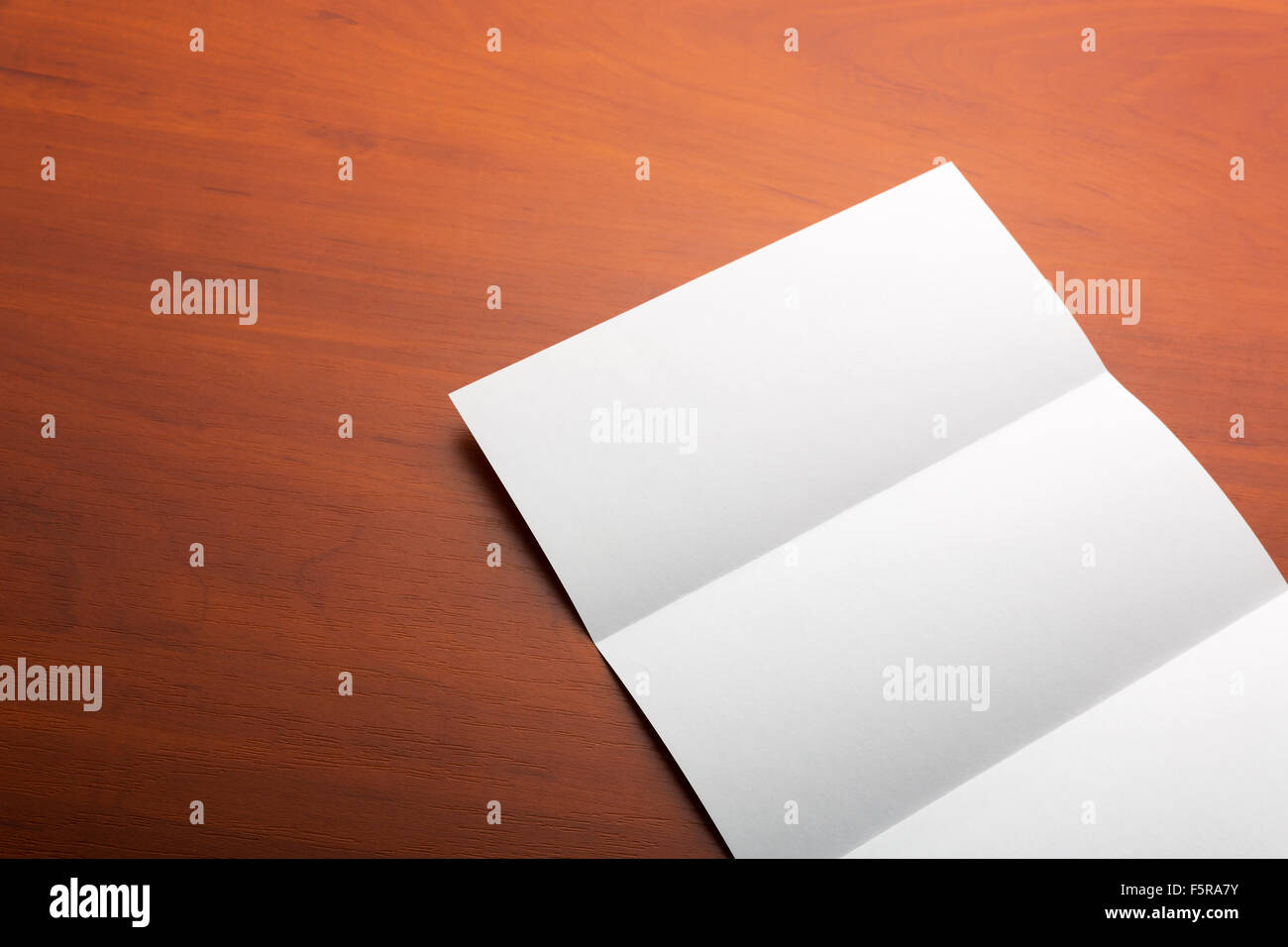 Open sheet of paper on a wood Stock Photo - Alamy