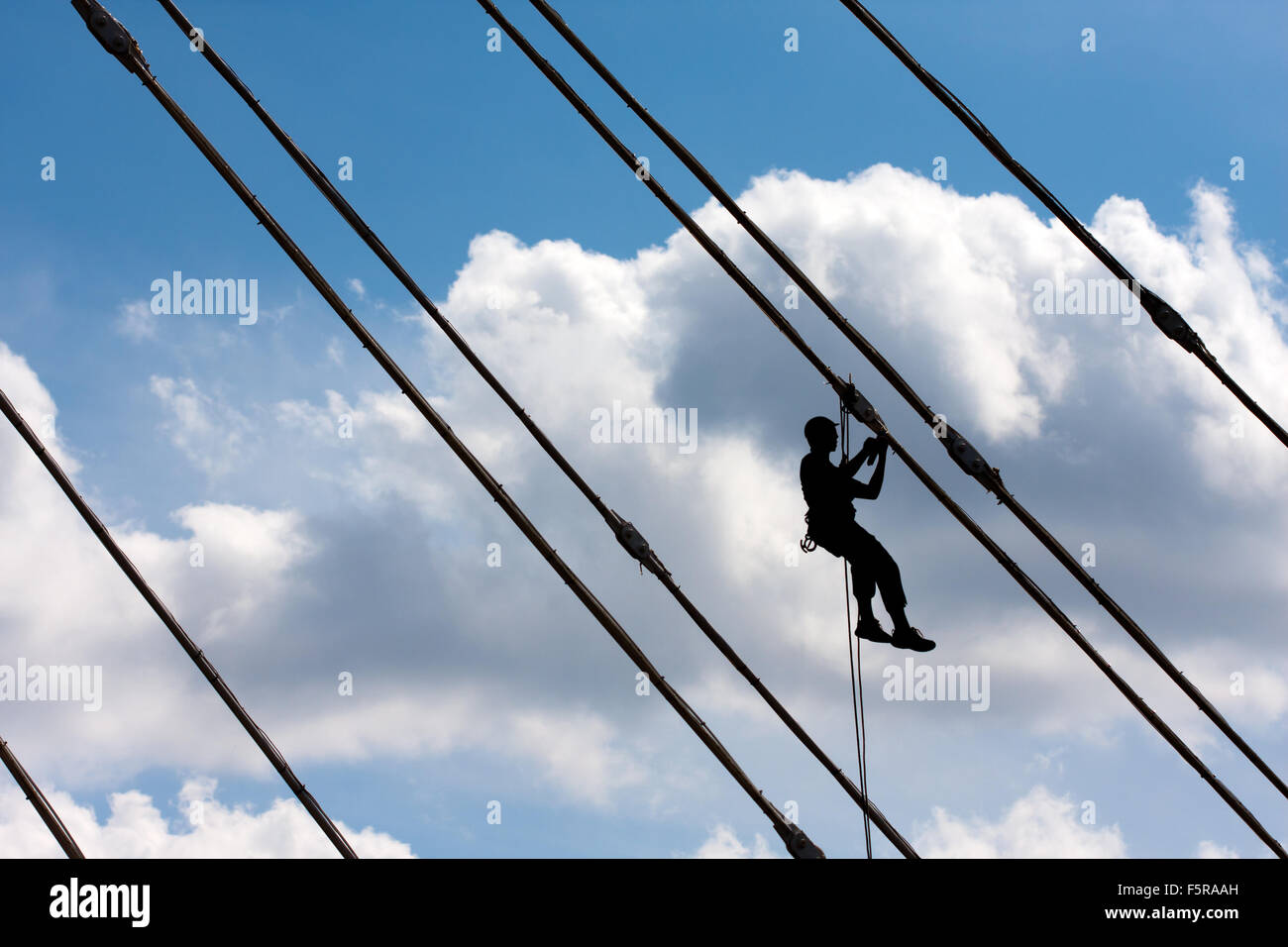 Silhouette of construction climber against blue sky Stock Photo - Alamy