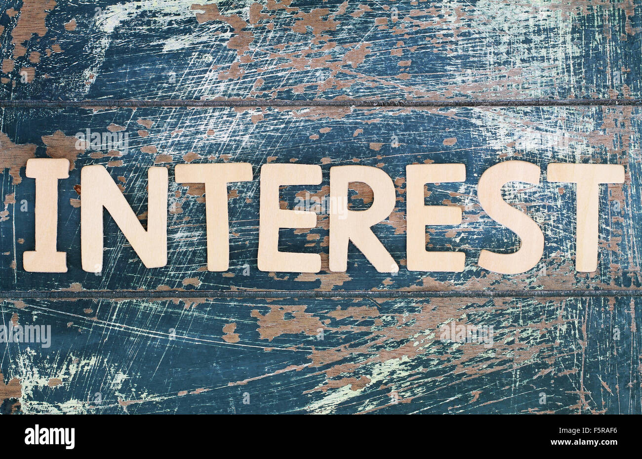 Word interest written with wooden letters on rustic wooden surface ...