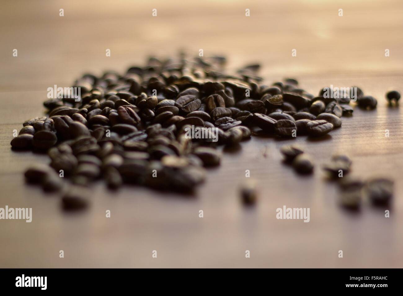 spilled coffee beans on the table in detail Stock Photo - Alamy