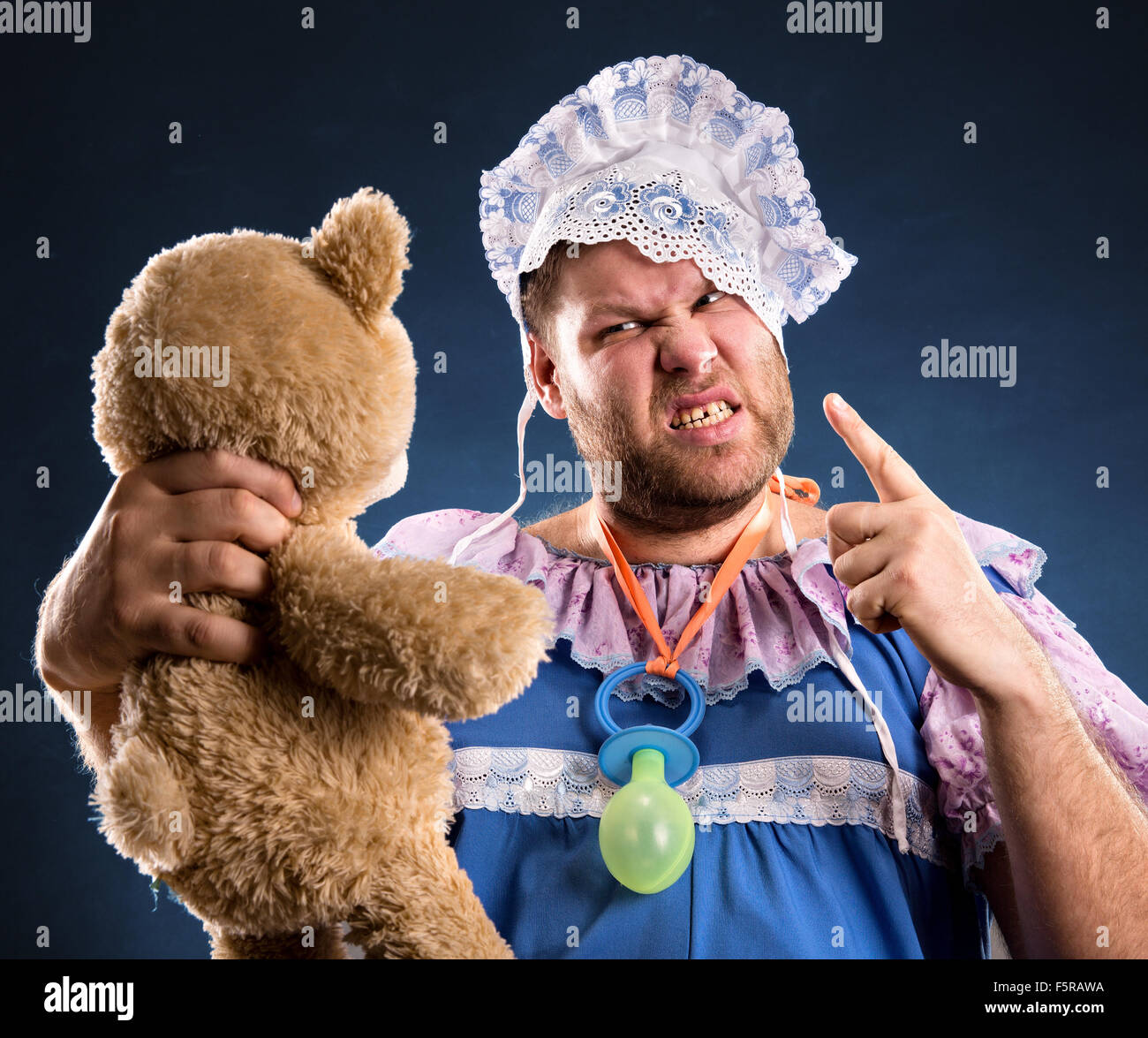 Angry man with toy bear in studio Stock Photo - Alamy