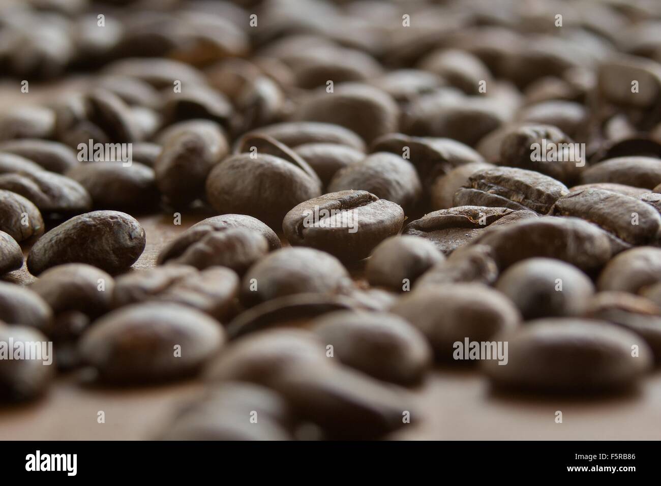 spilled coffee beans on the table in detail Stock Photo - Alamy
