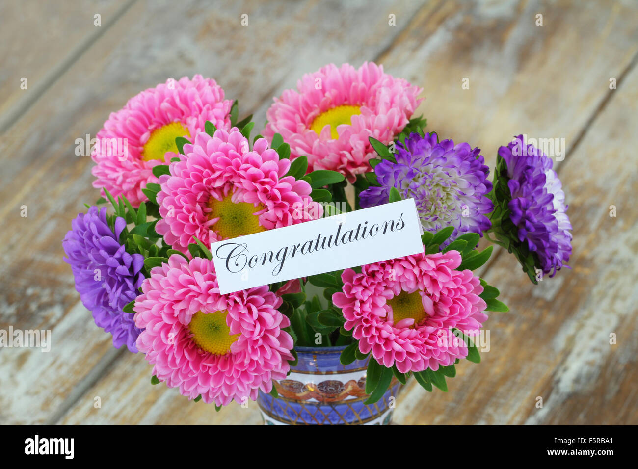 Congratulations card with colorful aster bouquet on rustic wooden ...