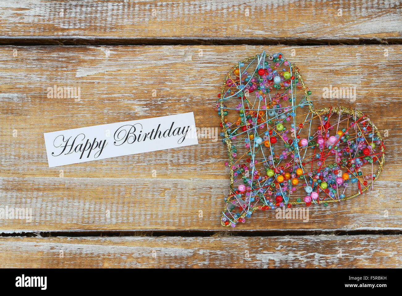 Happy Birthday card with heart made of colorful beads on rustic wooden ...