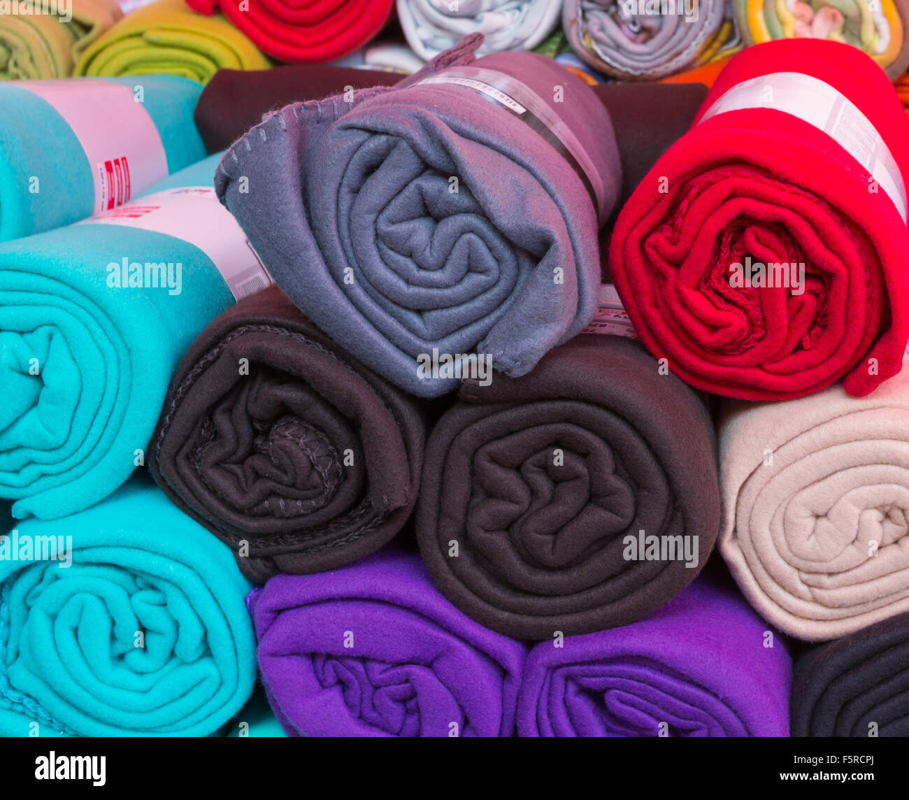 Many rolled colorful fleece blankets Stock Photo - Alamy