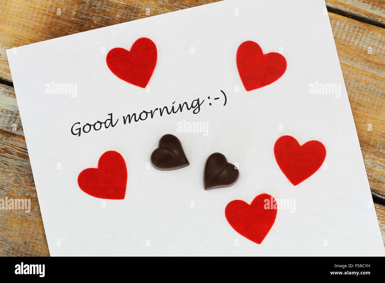 Good morning written on white paper with red hearts and heart shaped ...