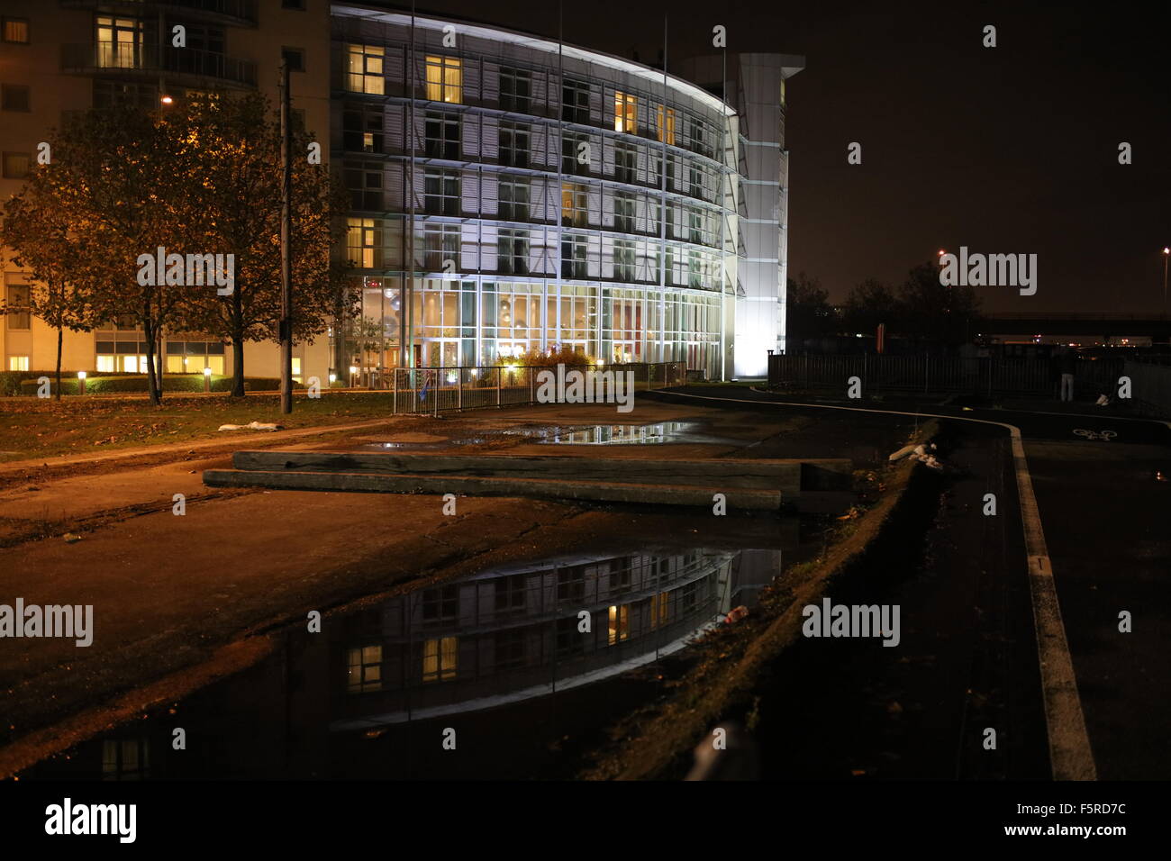 House at night with reflection in puddle Stock Photo - Alamy