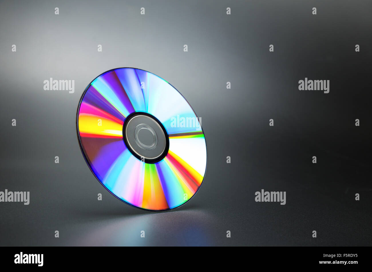 Compact disk on grey background Stock Photo - Alamy