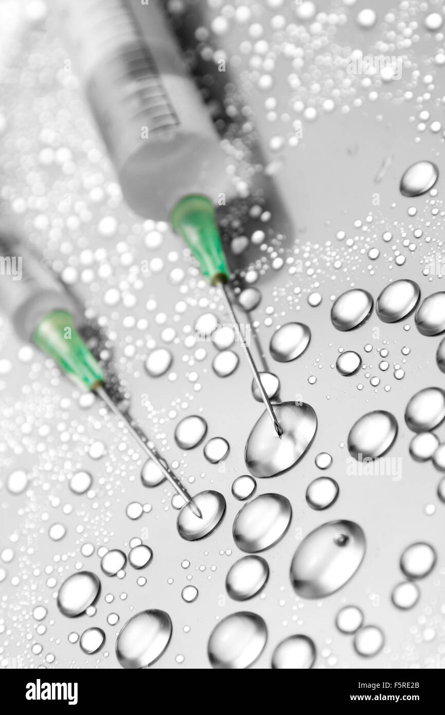 Two medical syringes and water drops Stock Photo - Alamy