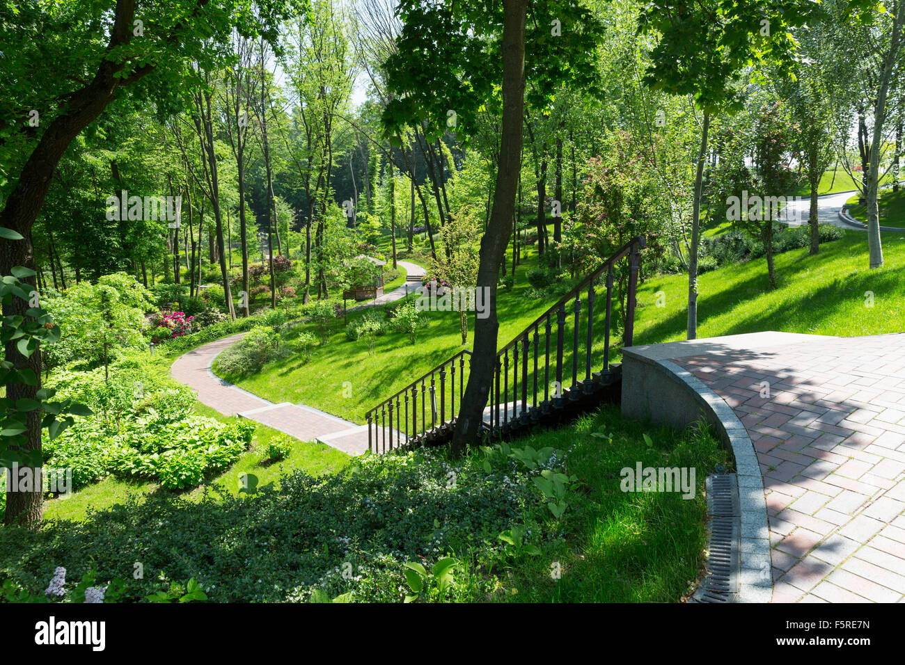 View of beautiful spring green park with long alley Stock Photo - Alamy