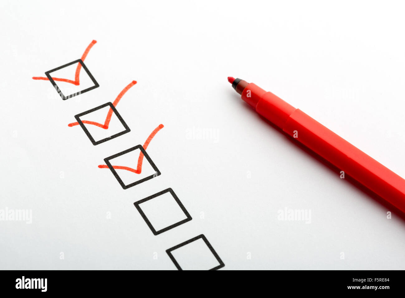 Check boxes and pen on white background Stock Photo - Alamy