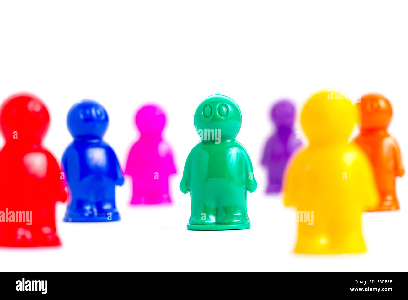 Crowd of the colorful toy people on white and a lot of copyspace on the ...