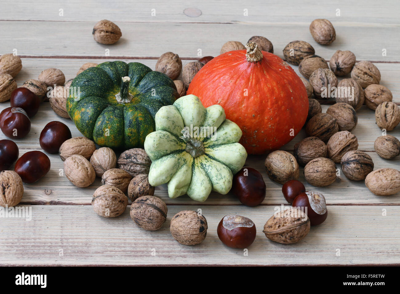 Still life with products of autumn - pumpkins, gourds, nuts, chestnuts ...