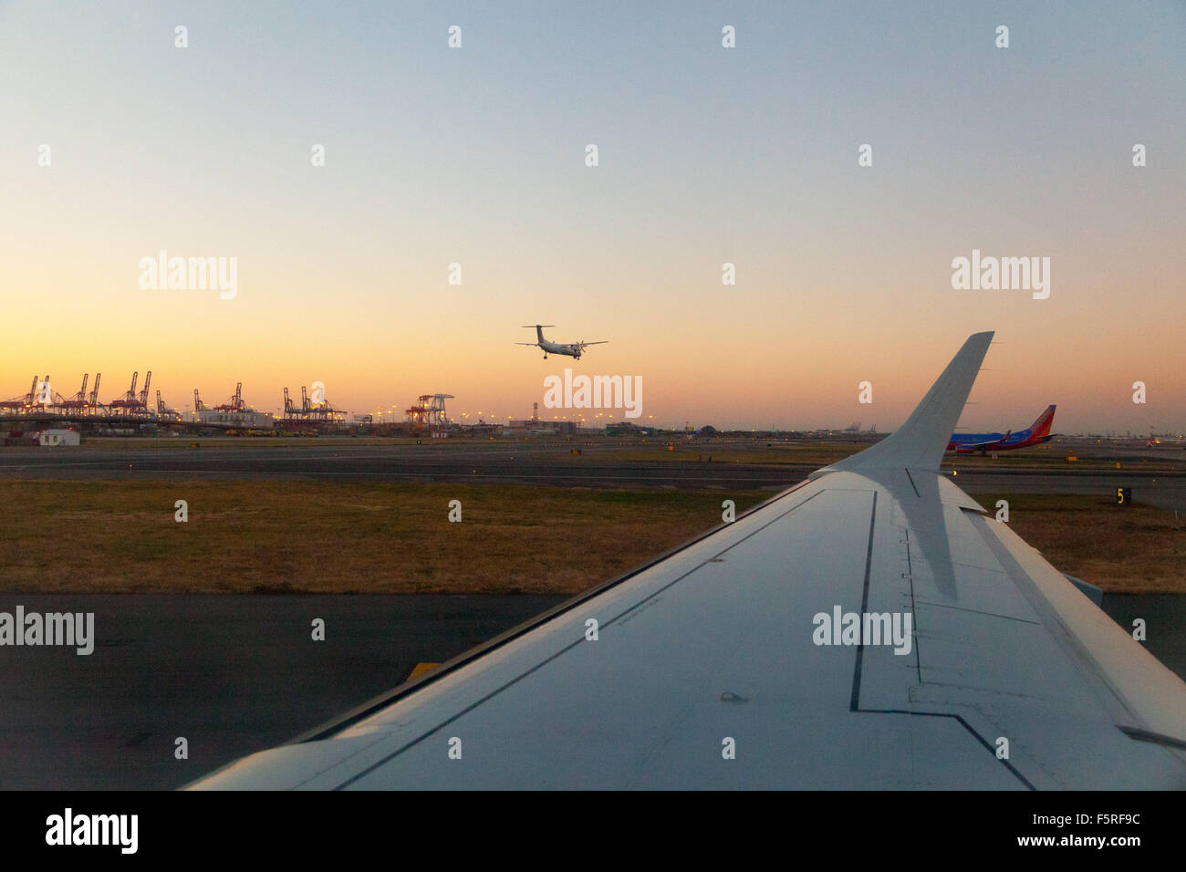 looking out the plane window across the wing of the plane to see ...
