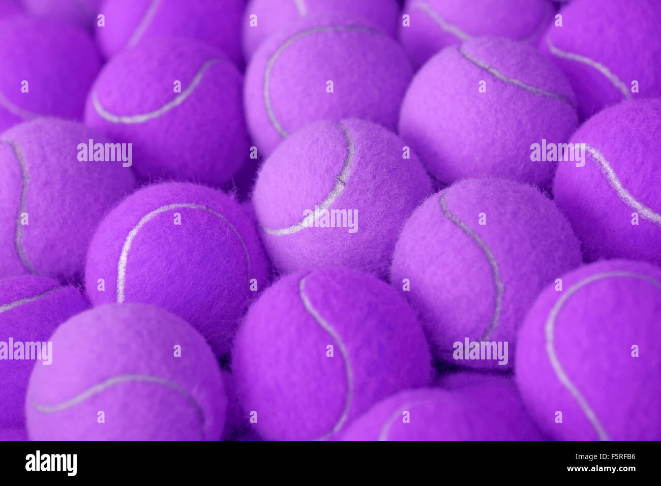 exotic purple tennis ball as sport background Stock Photo - Alamy