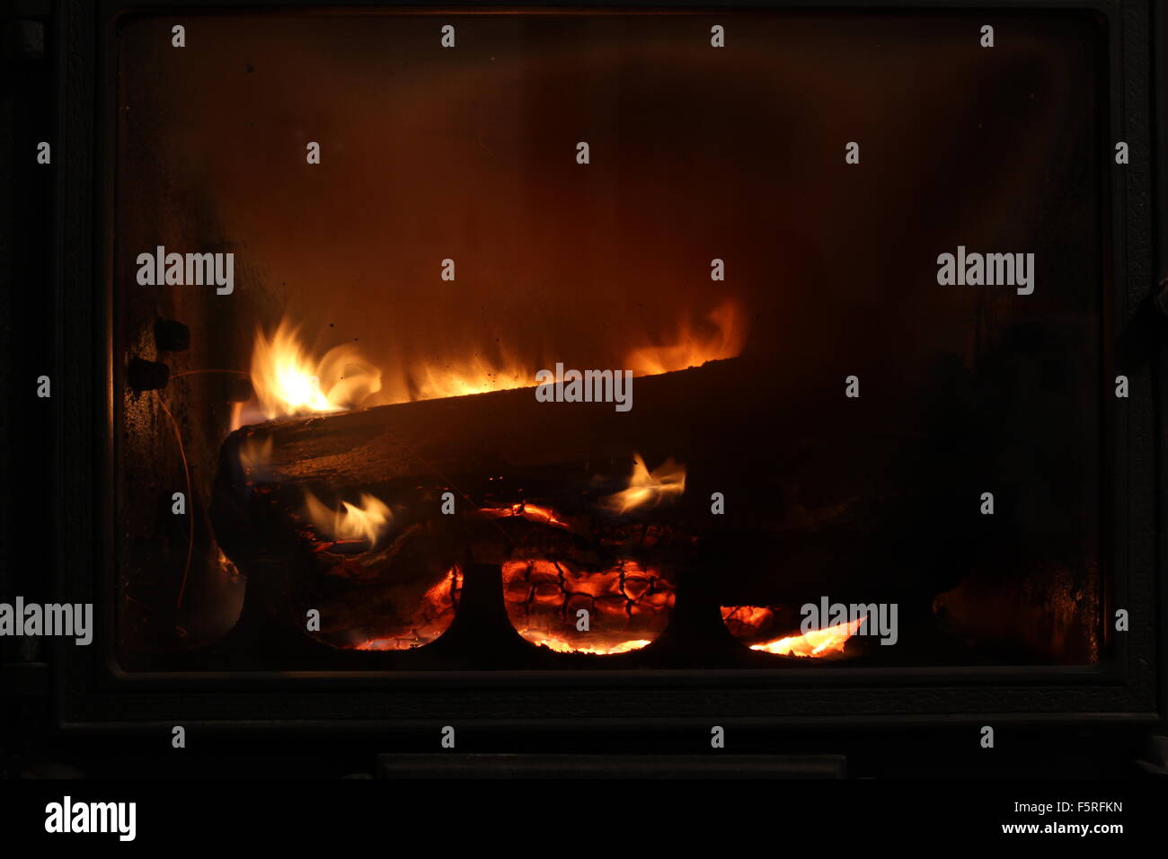 Fire behind the fire screen Stock Photo - Alamy