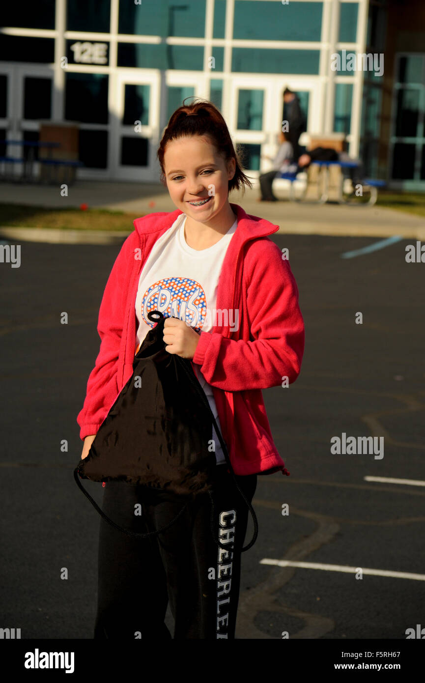 Teen girl in front of school with backpack Stock Photo - Alamy