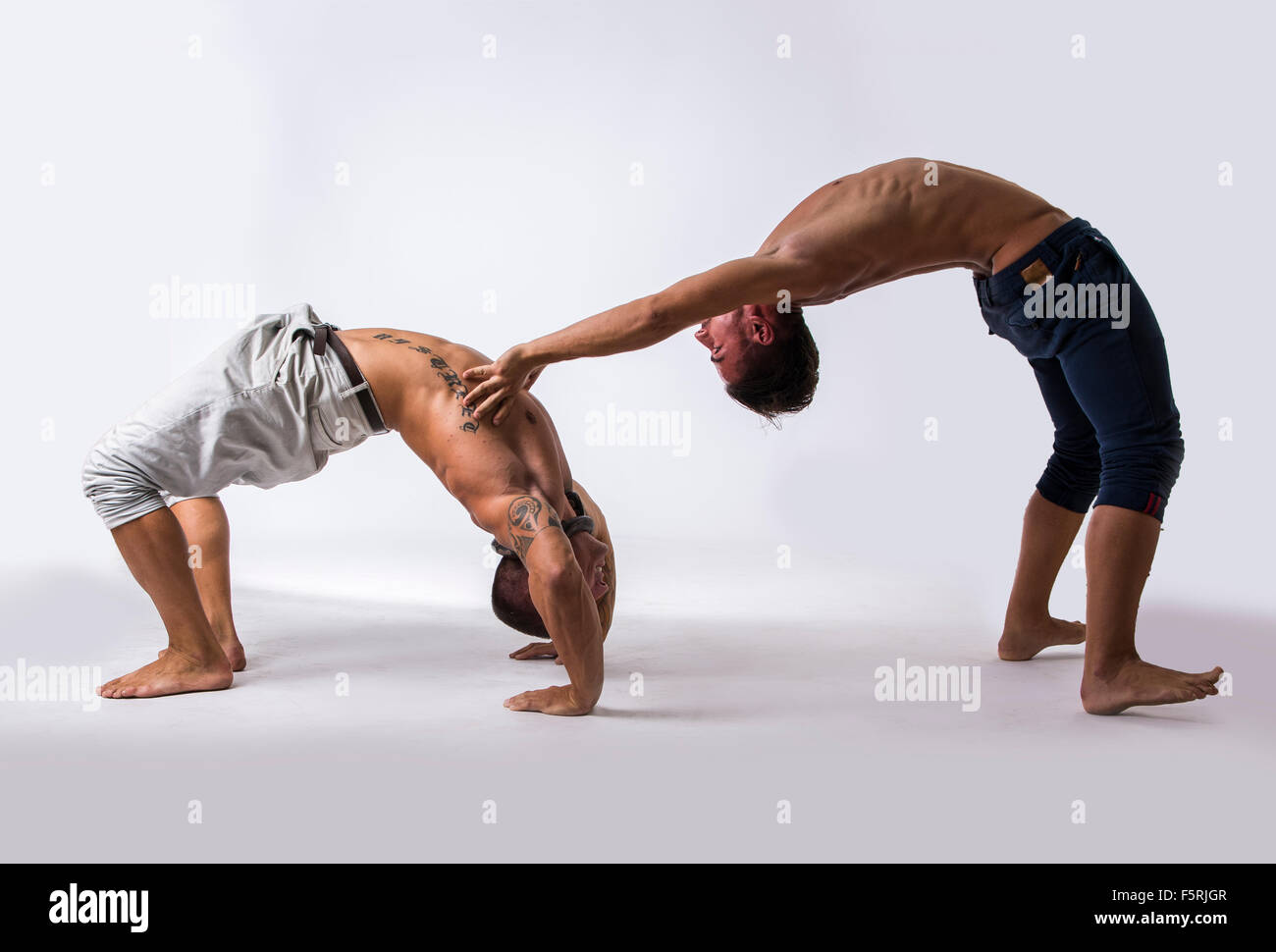 Muscular Shirtless Male Acrobatic Dancers Balancing on Top of Each ...