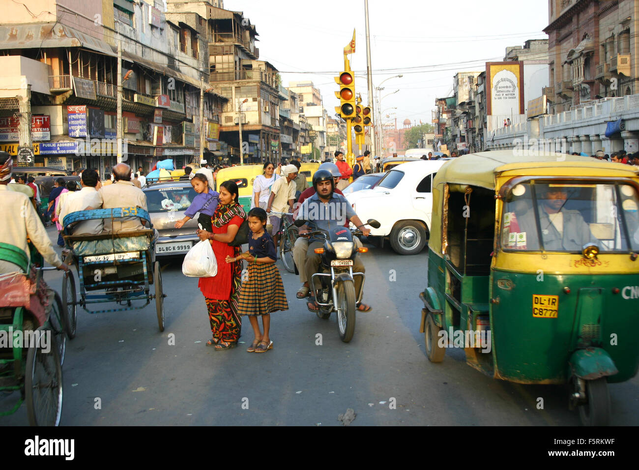 Delhi,India March 27 2004 : A woman and her children try to cross the ...